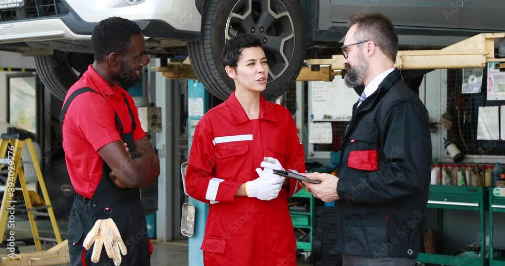 Professional car mechanic Teamwork in workshop concept. Diversity group ...