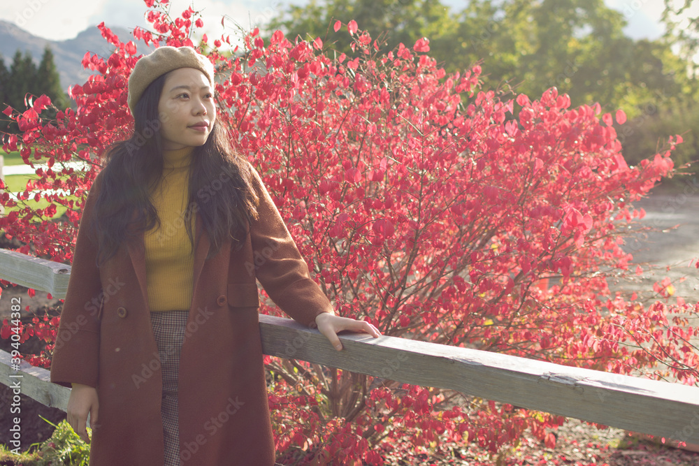 Young Asian Woman Wearing Fall / Autumn Attire Leaning By A Fence Stock ...