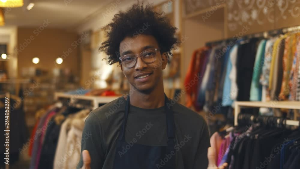 Portrait of african male owner of fashion store talking to client Stock ...