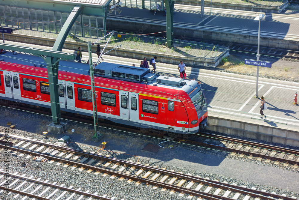 Commuter train at a station and with commuters Stock Photo | Adobe Stock