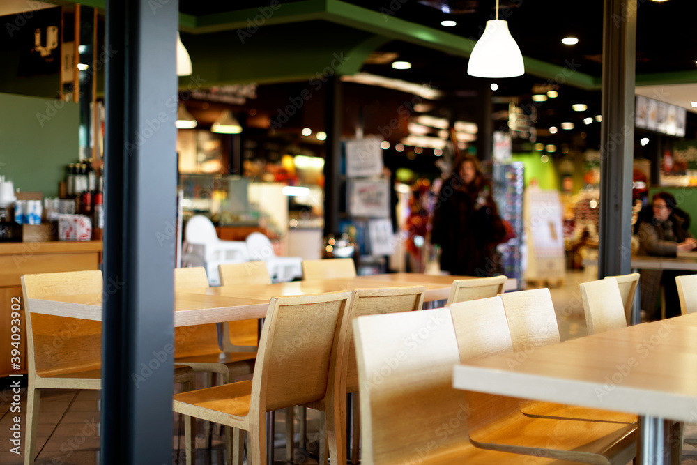 View of wooden tables and chairs in a motorway cafe self service ...