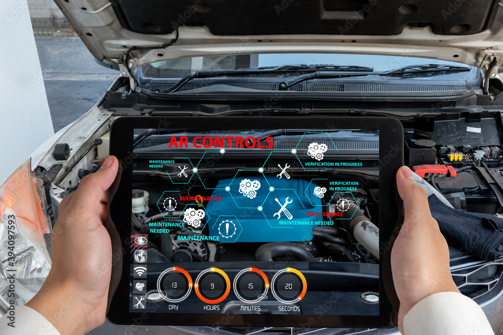 Engineer use augmented reality software to monitor parts of car vehicle ...