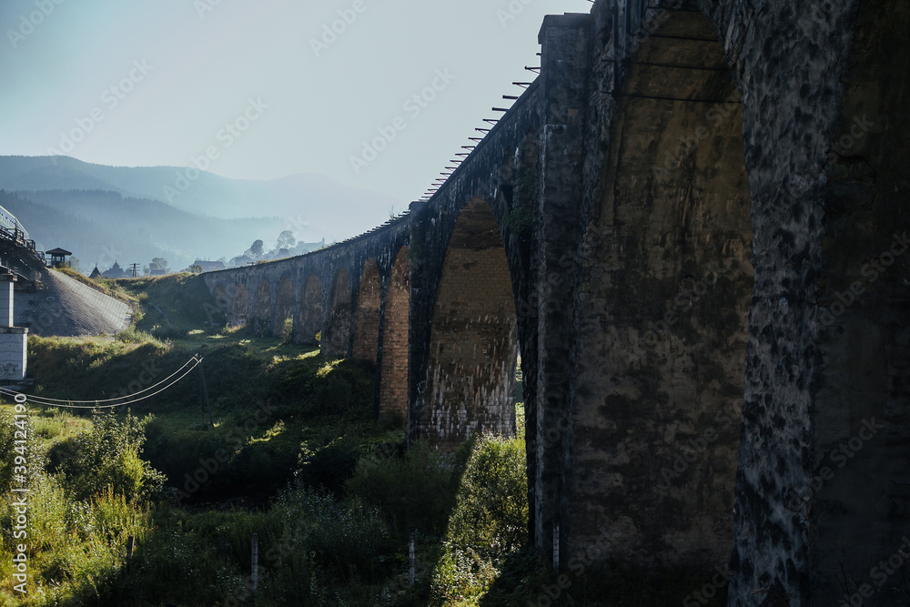 Beautiful old stone bridge in mountains. The railway ancient stone ...
