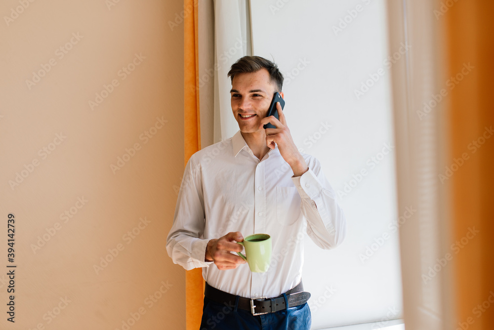 Relaxed young man resting from work. Man enjoy break stretching in home ...