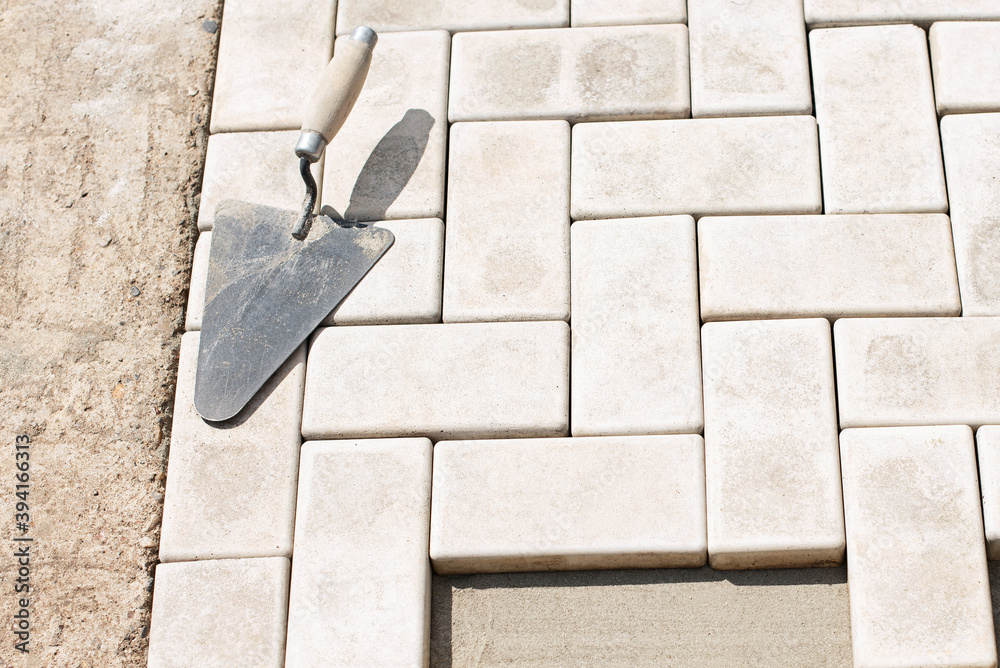 The master lays paving stones in layers. Garden brick pathway paving ...