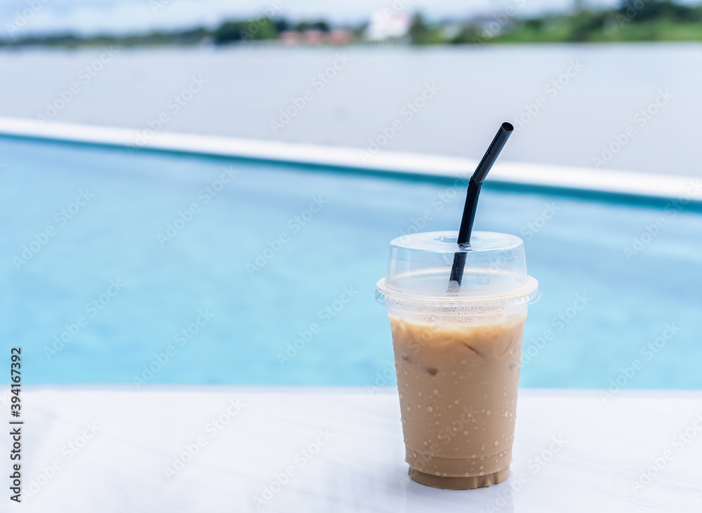 Iced coffee or Iced latte coffee in a plastic cup on the table at the ...
