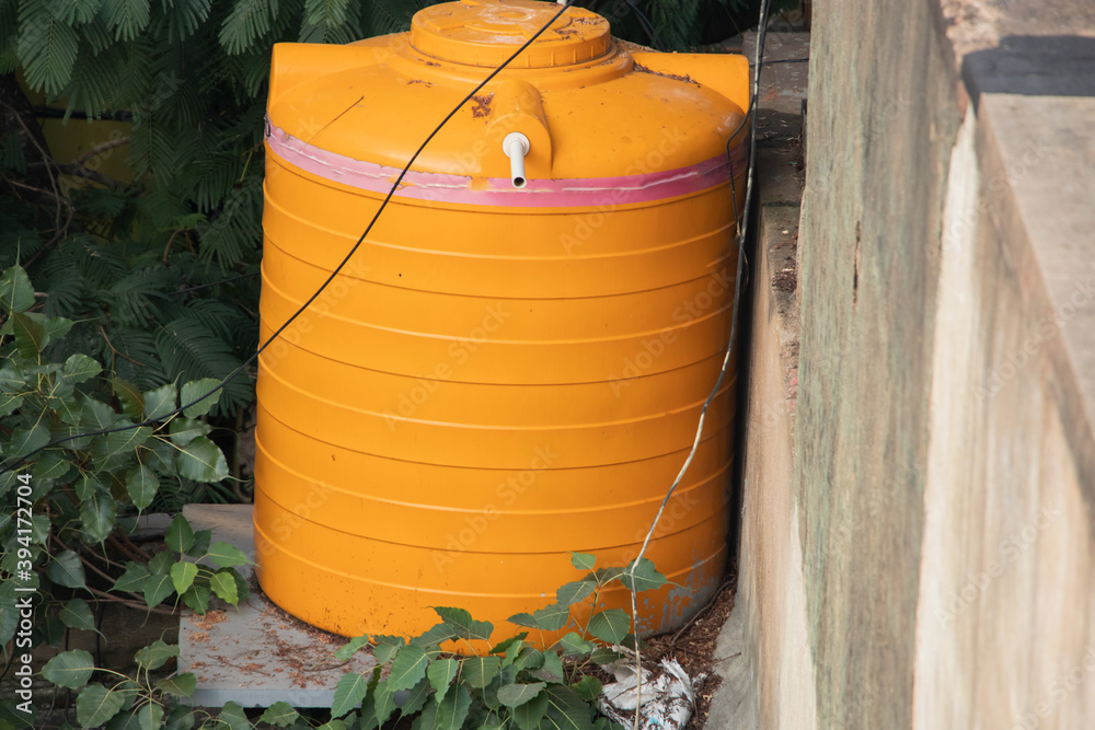 Yellow color Water tank kept on top of the home to store water in India ...