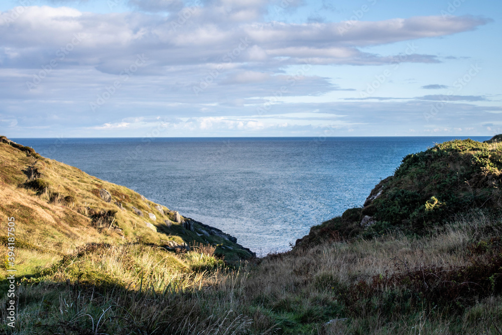 Hiking along the coastal cliffs of West Cork Ireland. Mark and unmarked ...