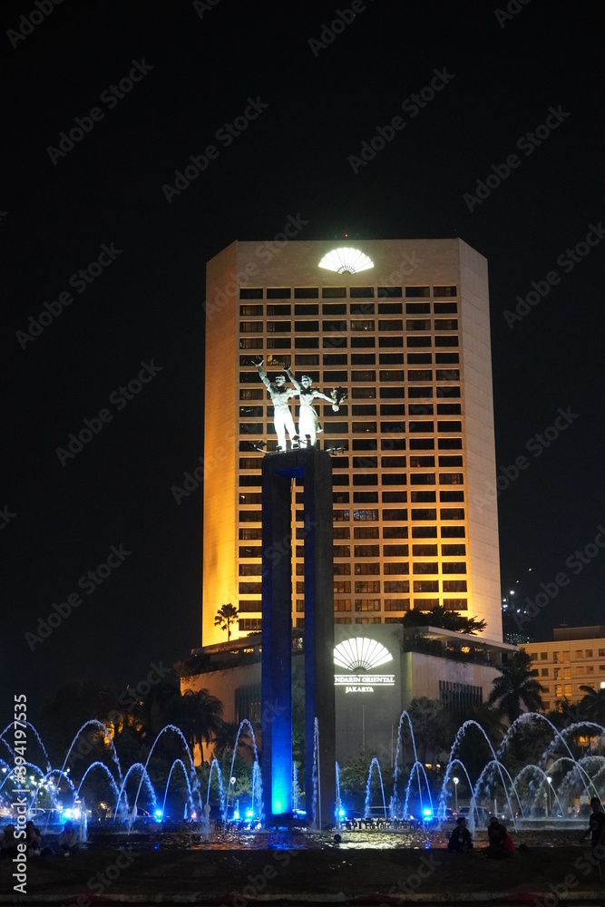 Colorful fountain show at iconic statue of Patung Selamat Datang at ...