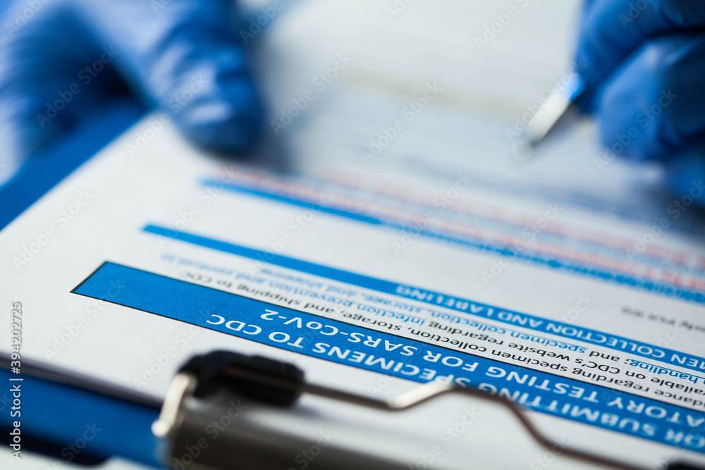 Laboratory technician checking CDC specimen submitting form, laboratory ...