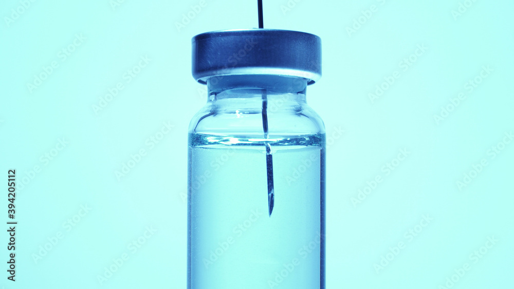 Filling syringe with vaccine from vial, extreme macro. Administrating ...