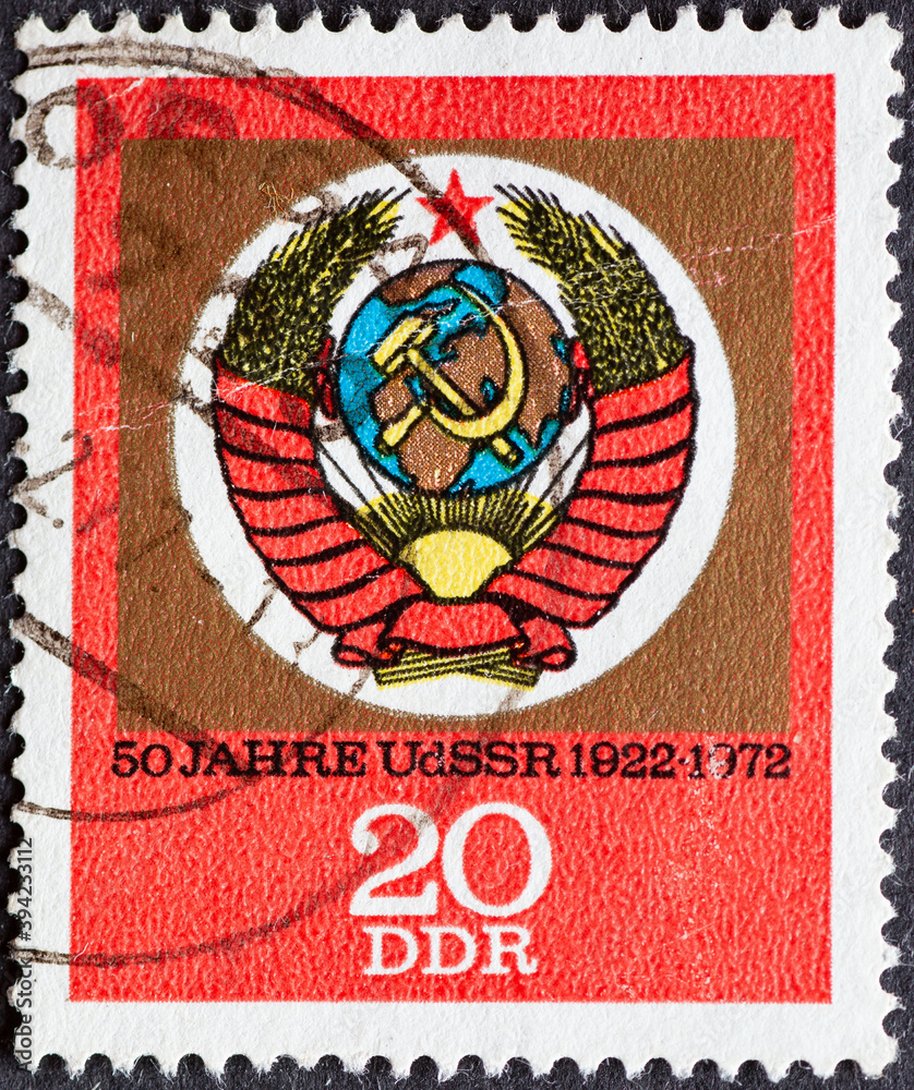 GERMANY, DDR - CIRCA 1972: a postage stamp from Germany, GDR showing the emblem of the USSR with ...