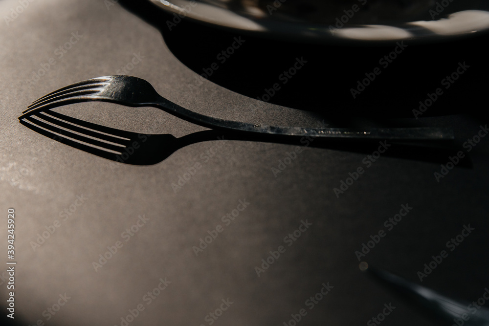 beautiful composition of kitchen items with shadows on a black ...