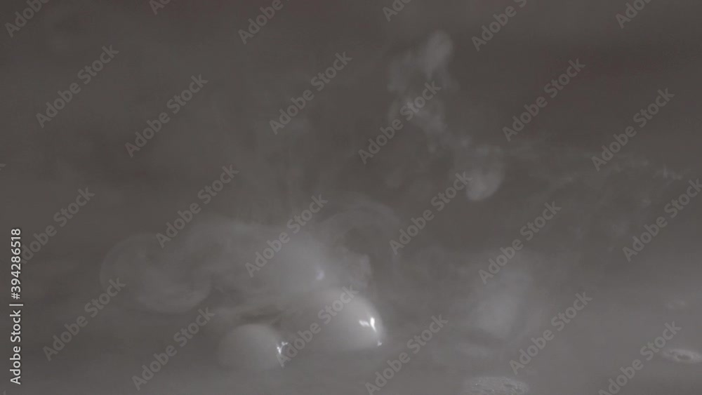 Smoke gas bubbles made with dry ice pop in the air, visual texture eff ...