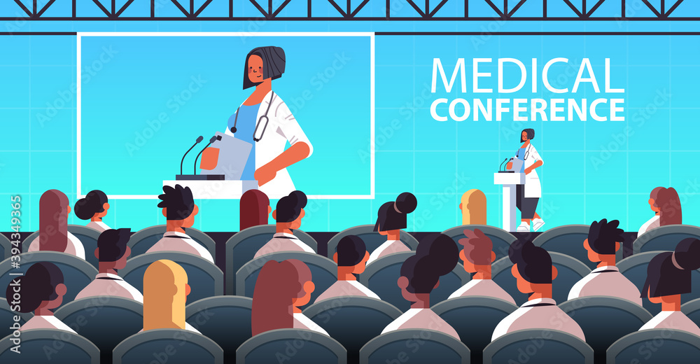 female doctor giving speech at tribune with microphone medical ...