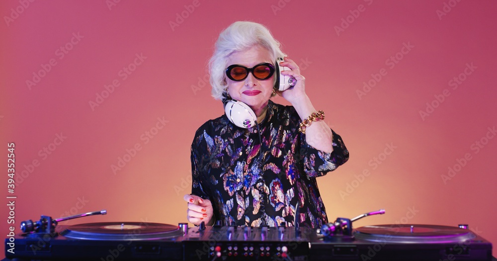 Cheerful and cool stylish Caucasian retro female DJ on retirement ...