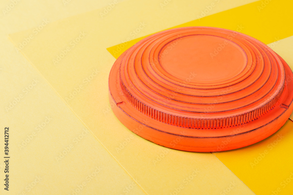 Clay target for skeet shooting against the colorful yellow background ...