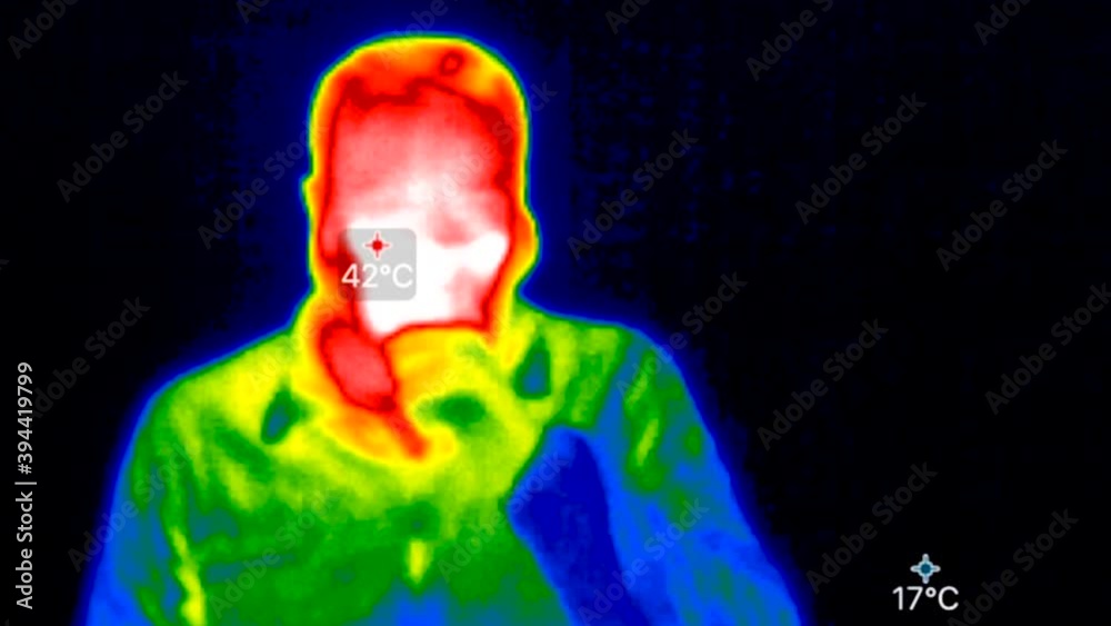 Thermal imaging camera detecting elevated temperature. Sick man with ...