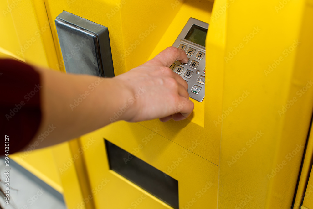 The girl enters the numeric pickup code for the parcel into the parcel ...