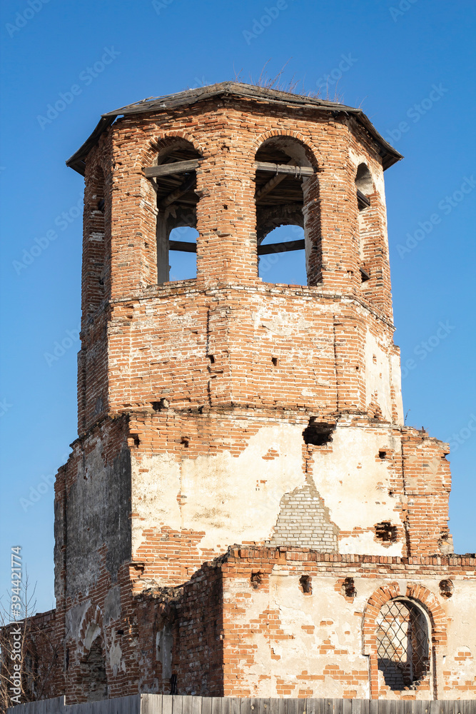 Bell tower, the old brick ancient building against the blue sky ...