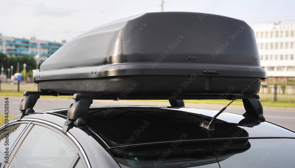 Car with the roof rack with cargo box. Luggage box mounted on the roof ...