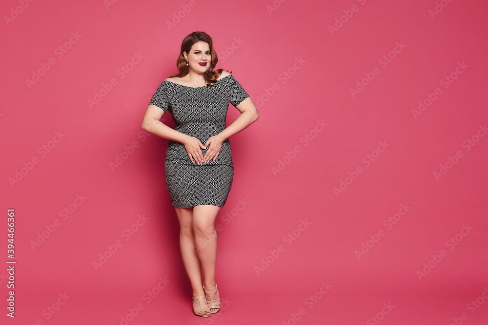 Plus-size model girl with bright makeup and with stylish hairstyle in a ...