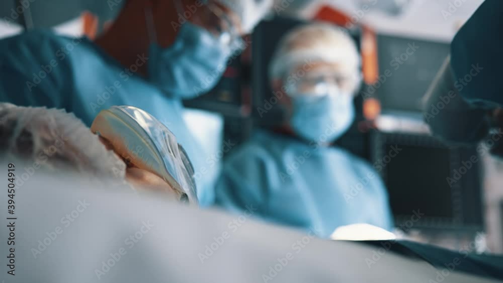 Female young adult patient undergoing plastic surgery in operating room ...