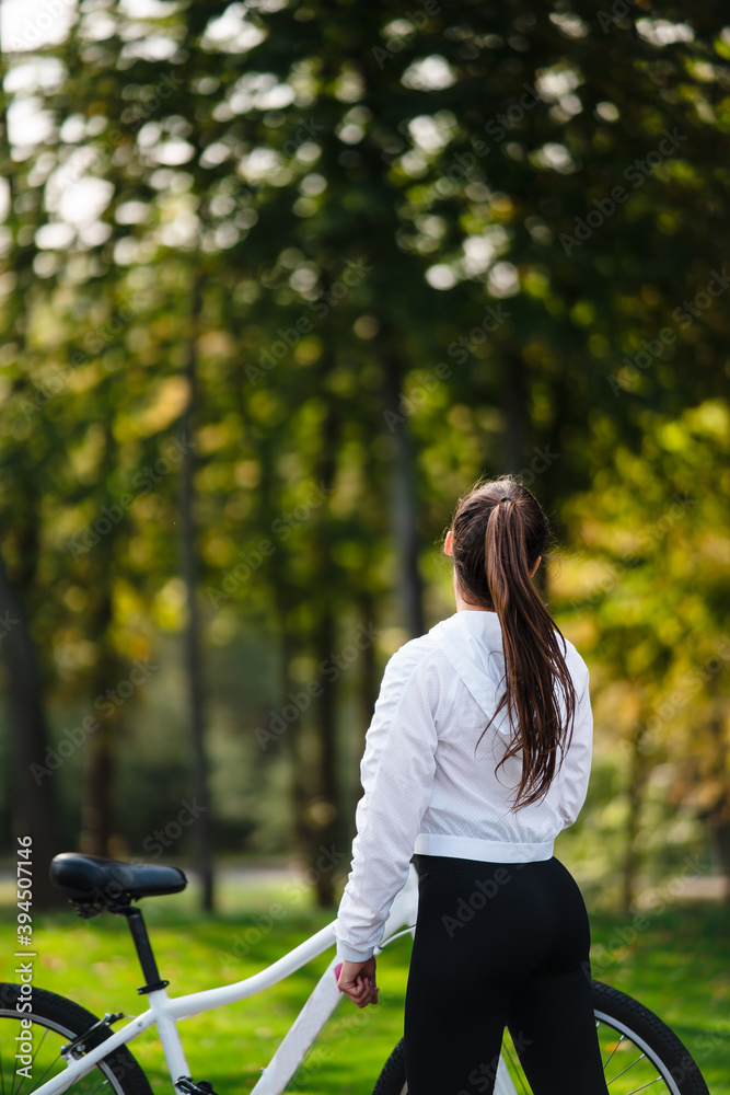 Beautiful girl posing at white bicycle. Walk in nature. Stock Photo ...