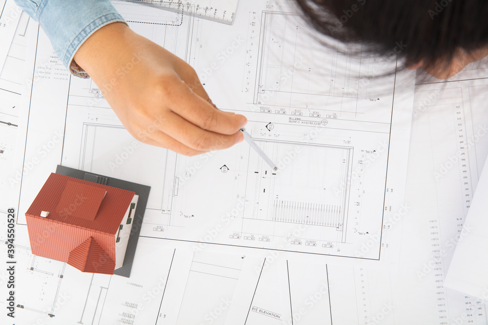 Architectural design engineers check construction drawings through ...