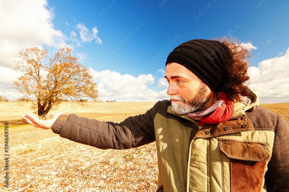 Optical Illusion Of Man Holding Tree On Field Stock Photo | Adobe Stock