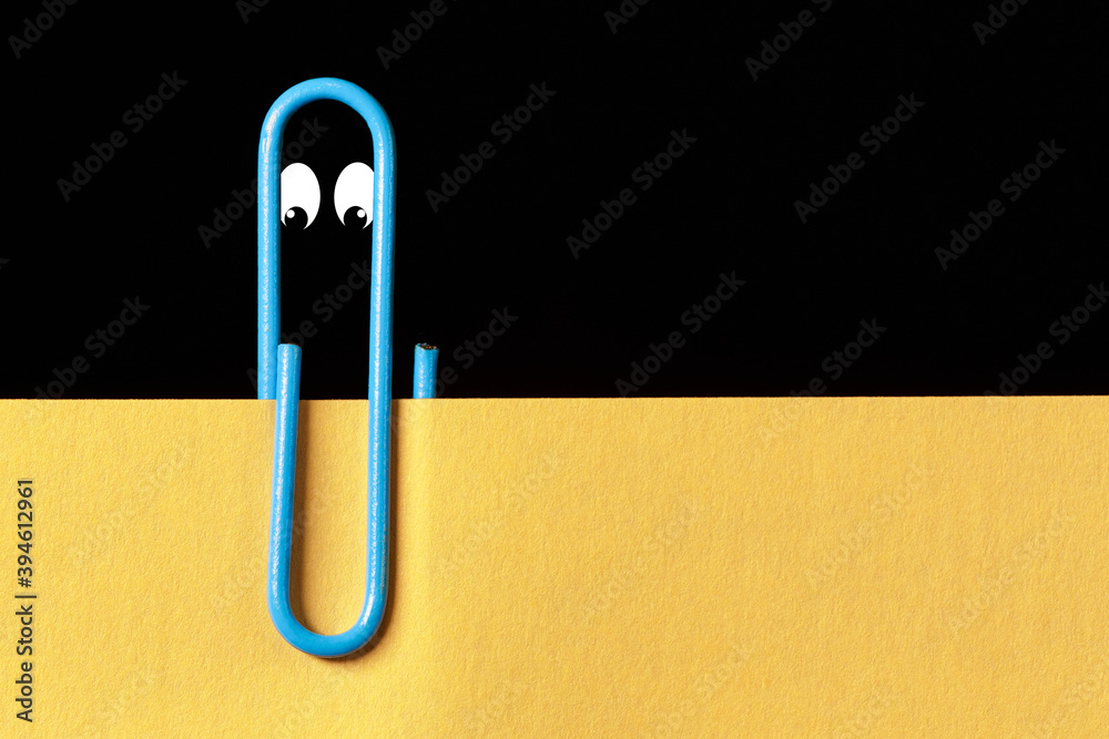 Paperclip with eyes and a sheet of paper Stock Photo | Adobe Stock