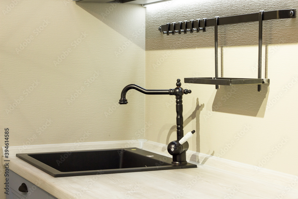 black porcelain tile kitchen sink on the kitchen countertop and retro ...