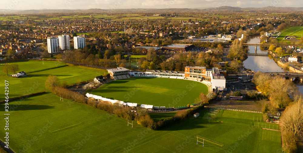 Giant cricket ground surrounded by trees and fields Stock Photo | Adobe ...