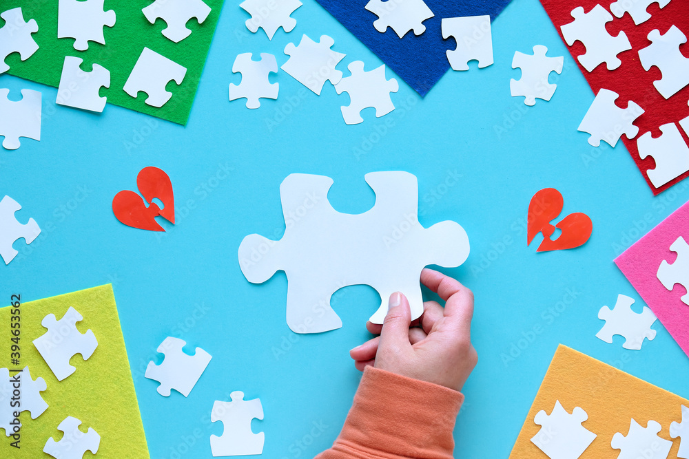 Autism awareness concept. Flat lay, hand, jigsaw puzzle pieces. Text ...