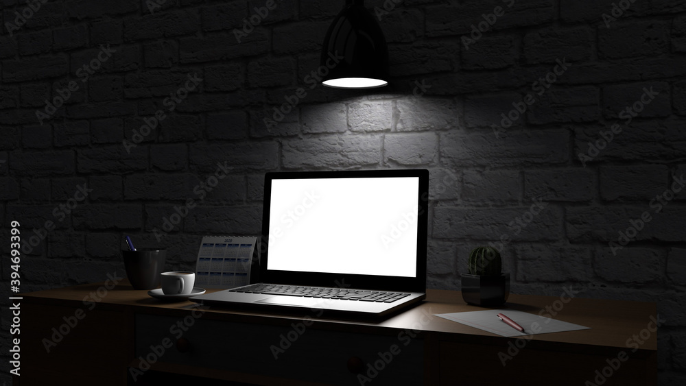 Laptop in dark with an overhead light and workspace mockup with ...