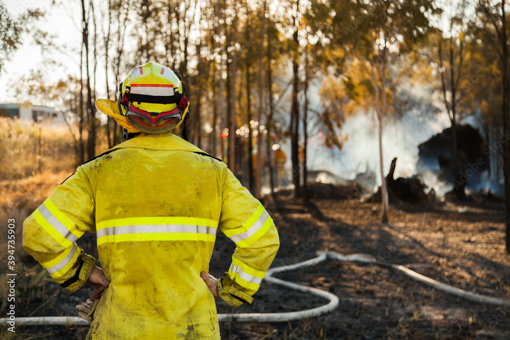 Fire and rescue man in fire brigade out at a grass fire emergency site ...