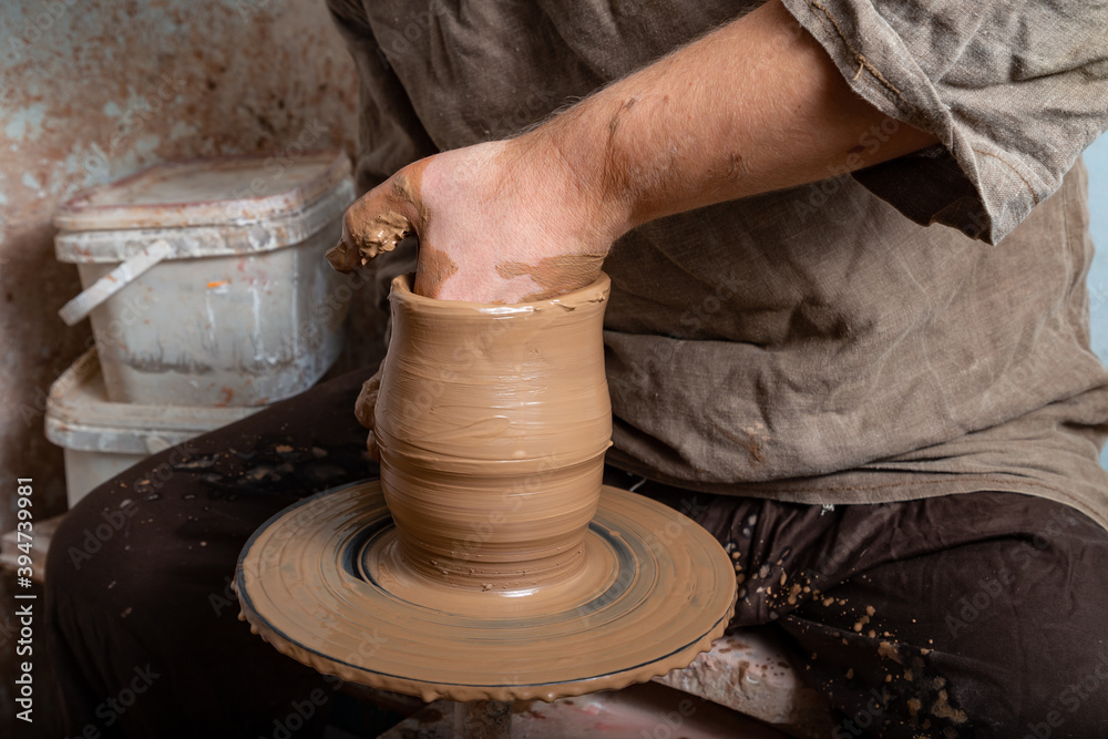 Creating a pot of clay close-up. Hands making products from clay ...