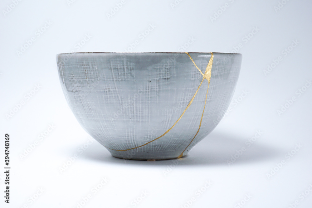 Kintsugi Japanese grey bowl. Gold cracks restoration on pottery ...