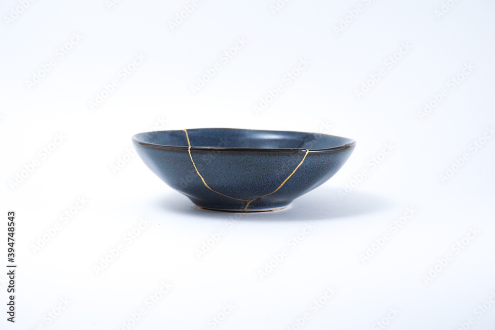 Blue kintsugi bowl. Gold cracks restoration on pottery restored with ...