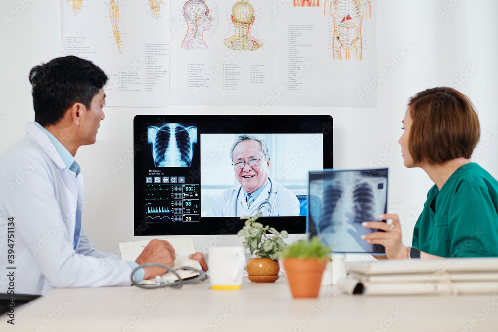 Group of Aisan pulmonologists discussing chest x-rays and new ways of ...