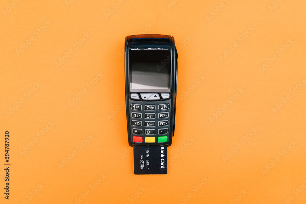 The bank card is inserted into the POS payment terminal. Electronic ...