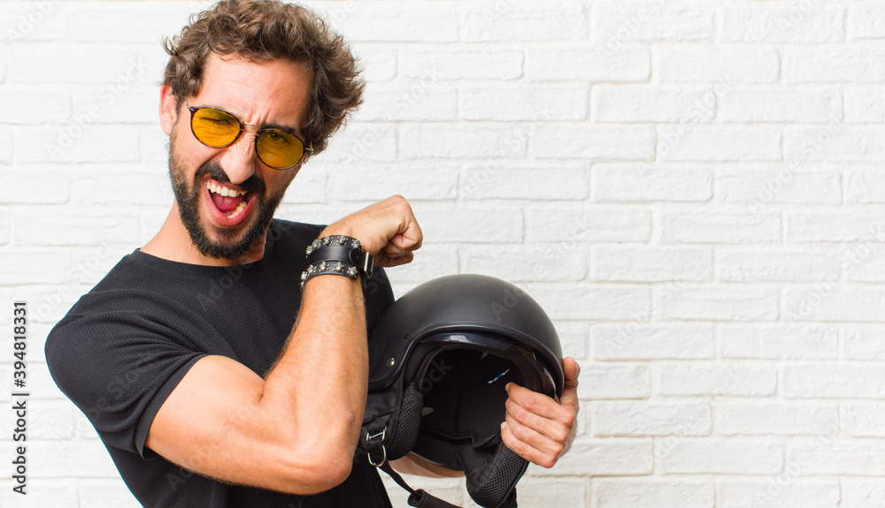 young man feeling happy, satisfied and powerful, flexing fit and ...