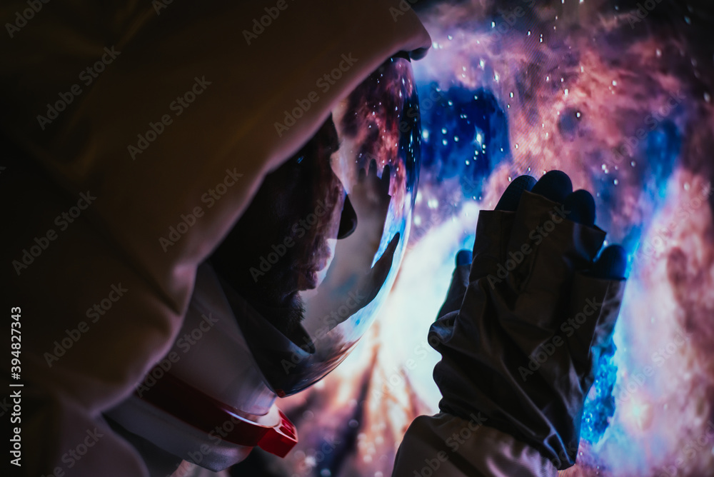 Astronaut looking deep space, galaxy and planets from the window of his ...