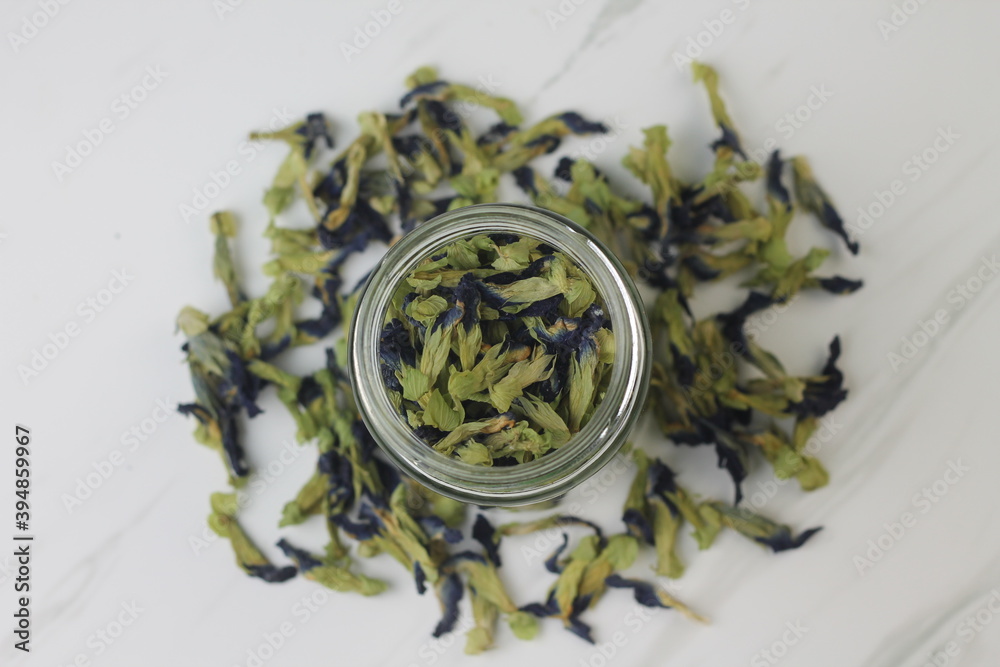 Bunga Telang Kering or Dried Butterfly Pea Flowers on a glass with ...