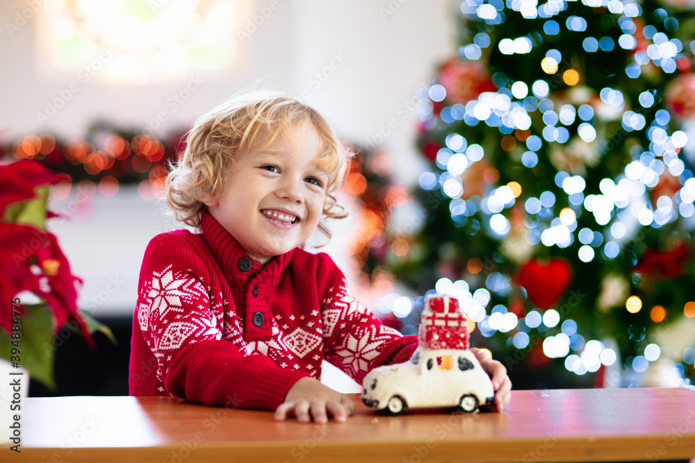 Child with Christmas present. Kid with Xmas gift. Stock Photo | Adobe Stock