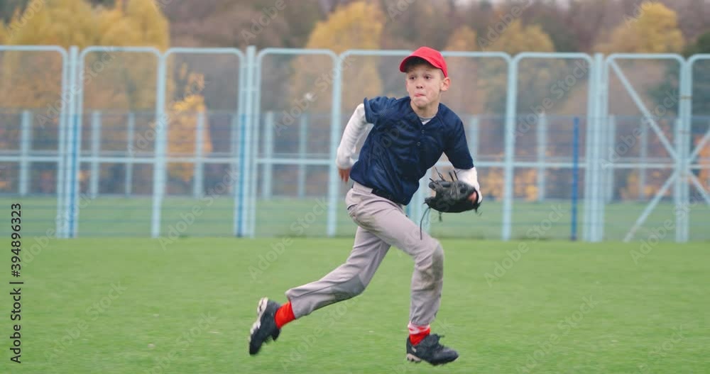 Baseball tournament at school, the boy pitcher successfully catches a ...