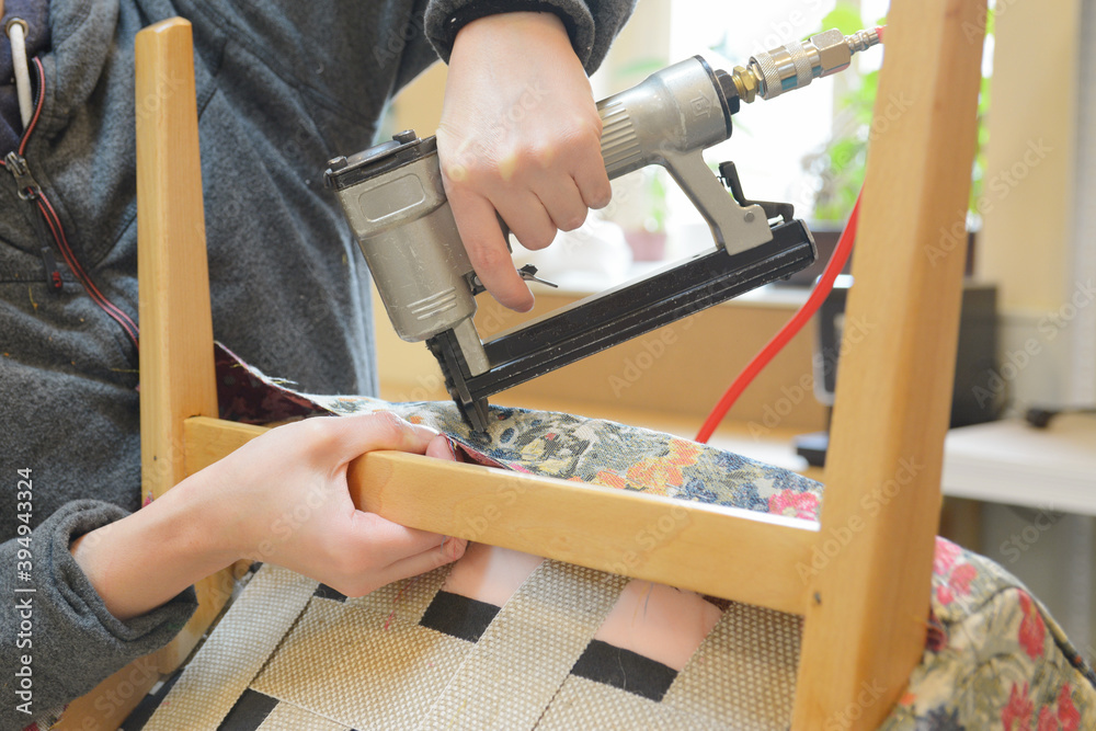 Making new upholstery on old chair. Woman hands working in upholstery ...