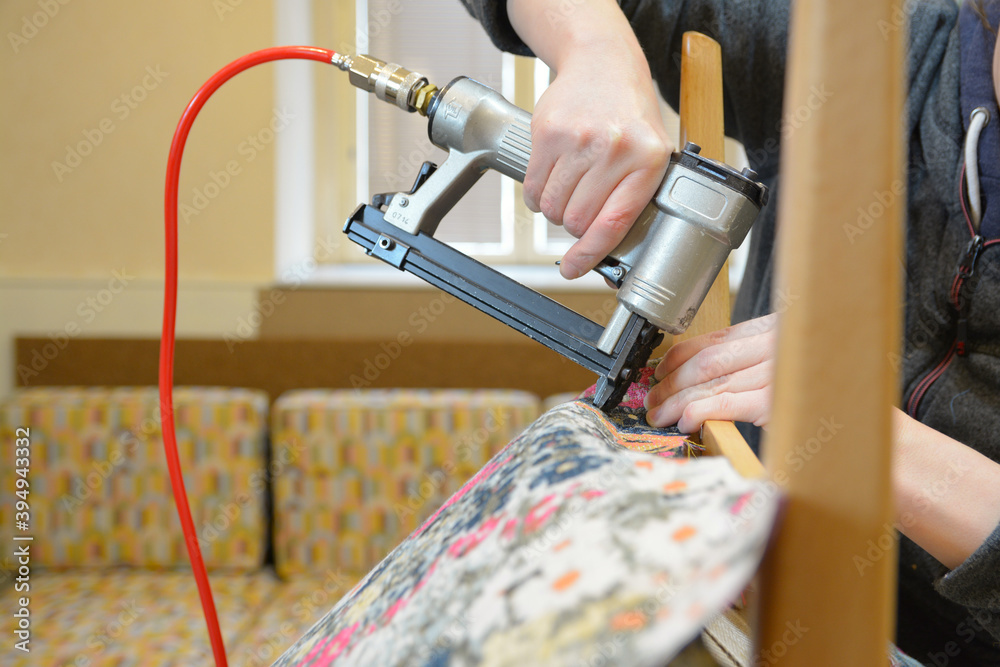 Foto de Making new upholstery on old chair. Woman hands working in ...
