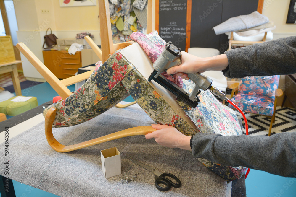 Making new upholstery on old chair. Woman hands working in upholstery ...