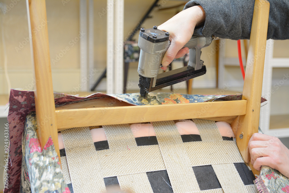 Making new upholstery on old chair. Woman hands working in upholstery ...